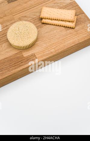 organic cake with buckwheat flour and biscuits on a wooden chopping ...