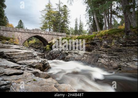 The stone bridge that goes over the rapids of the river Dee in the ...