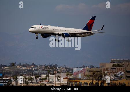 Delta Airlines Boeing 757 at LAX airport connected to jet bridge aerial ...