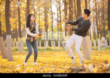 Happy young lovers frolicking in the woods Stock Photo - Alamy