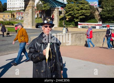 A steampunk dressed morris dancer eating a banana at Scarborough Stock ...