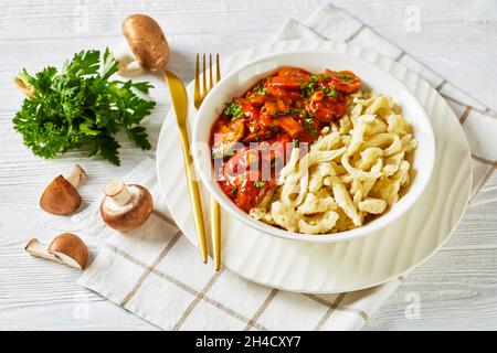 spaetzle with mushroom gravy in a white bowl, jagerspatzle ...