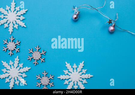 Christmass flatlay silvery snowflakes in shape frame and christmas tree ...