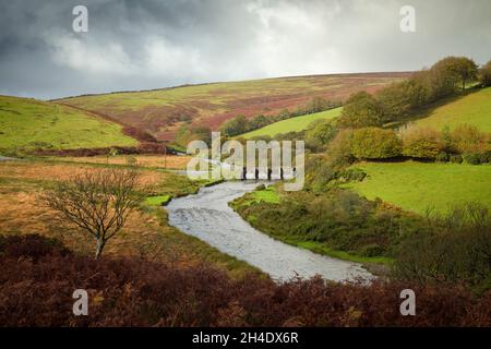 The medieval Landacre Bridge spanning the River Barle in autumn near ...