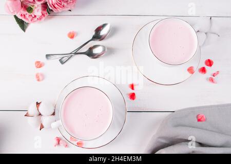 Two cups of pink matcha. Relaxing drink to improve sleep. Trendy vegan ...