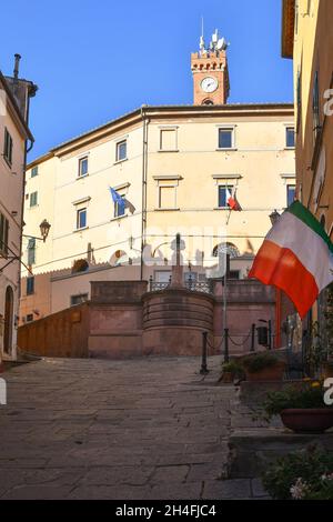 The medieval village of Castagneto Carducci with an uphill alley and ...