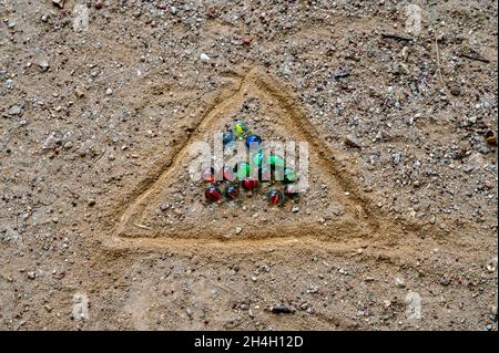 A collection of beads of various colors used in bead play, a ...