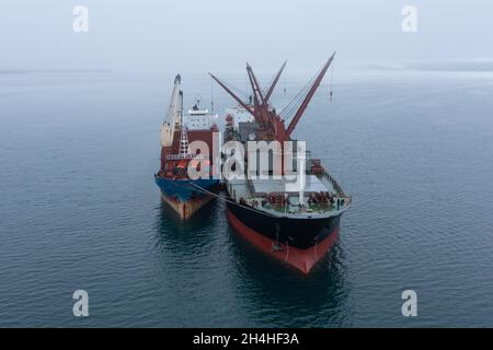 The dry-cargo ships costs in the sea. Vessels overload cargo Stock ...
