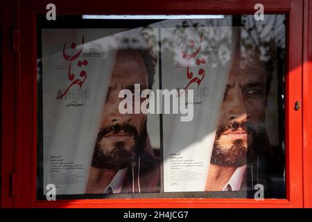 Tehran, Iran. 02nd Nov, 2021. A woman walks past "A Hero" movie poster ...