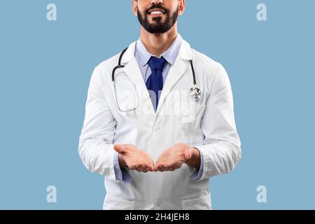 Unrecognizable Male Doctor Showing Invisible Object To Camera ...