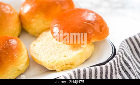 Step by step. Freshly baked brioche buns on a metal serving tray Stock ...