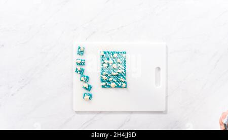 Flat lay. Drizzling melted white chocolate and sprinkling with white ...