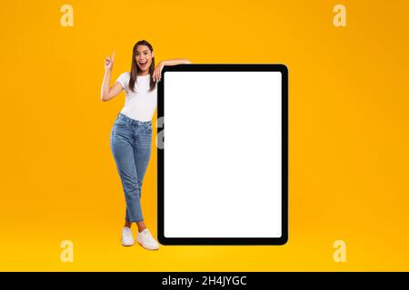 Great offer pointing at digital tablet white screen handsome man ...