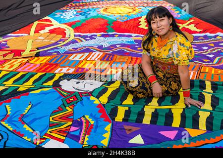 An indigenous woman from the Guna people wearing traditional beaded leg ...