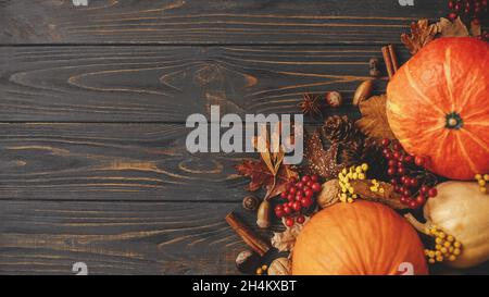 Pumpkins, autumn leaves, anise, acorns, cinnamon border on rustic dark ...