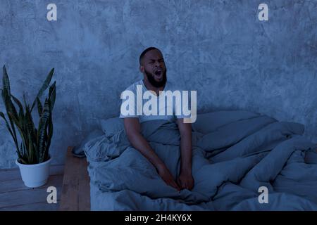 Bearded guy waking up and sitting down on couch then touching face ...