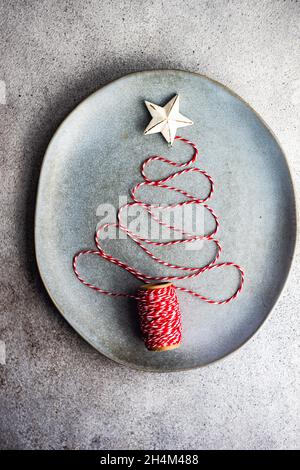 Christmas table setting with white plate and christmas decorations on ...
