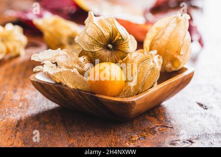 Physalis peruviana fruit on wooden table closeup Stock Photo - Alamy