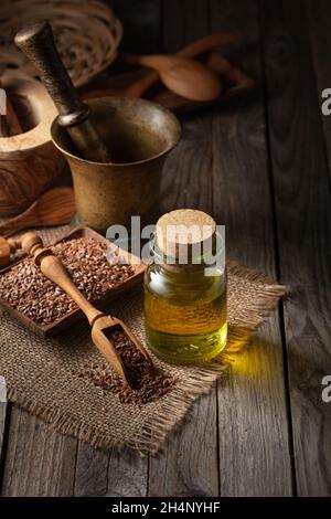 Flaxseeds and linseed oil. Linseed oil with kitchen utensils on an old ...
