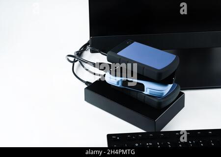 Multiple external hard drives connected to a monoblock on a white ...