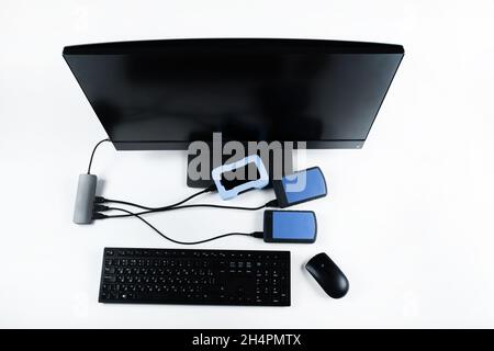 Multiple external hard drives connected to a monoblock on a white ...