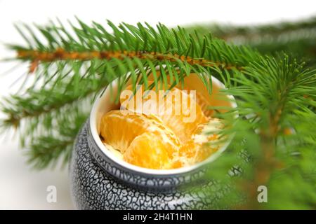 Close-up mug of lobule orange mandarin or tangerine on green natural ...