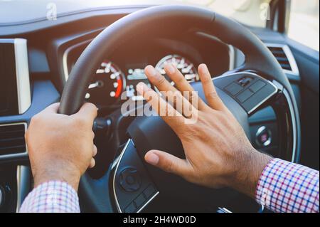 Male hand honking the car horn, man driving vehicle and beeping Stock Photo - Alamy
