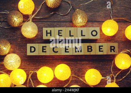 Hello December text message with LED cotton ball decoration on wooden ...