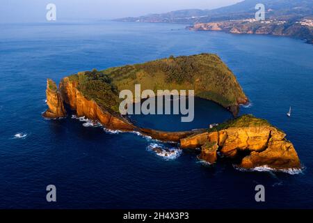 Aerial view of volcanic island of Vila Franca do Campo and sailboat ...