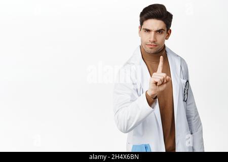 Doctor shaking finger in disapproval, prohibit something to patient ...