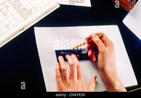 Graphic designer using Letraset, dry transfer lettering system in the ...