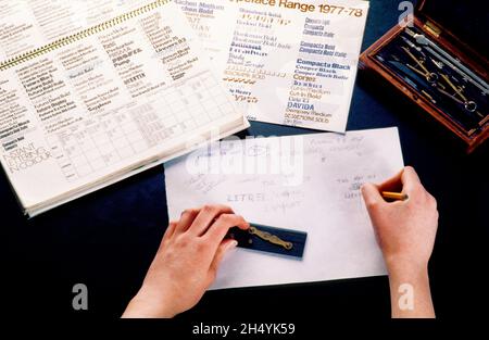 Graphic designer using Letraset, dry transfer lettering system in the ...