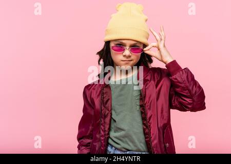 preteen girl in trendy outfit adjusting sunglasses isolated on pink, banner Stock Photo - Alamy