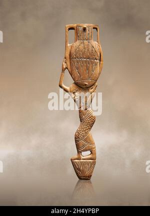 Ancient Egyptian wood cosmetic shadow spoon of a servant carrying an ...
