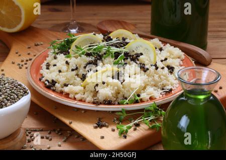 Couscous porridge with sprouts, sativa hemp seeds, lemon and wine Stock ...