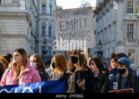 A demonstrator holds a sign that reads "Change hate for love" as ...