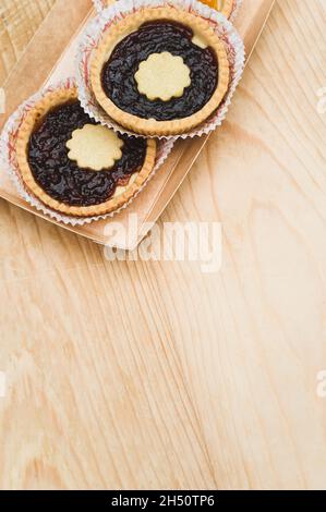 peach and cherry jam short crust pastry in a paper backing cup on a ...