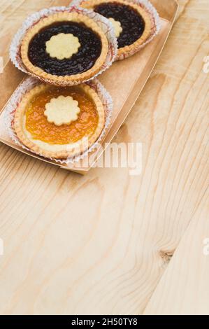 peach and cherry jam short crust pastry in a paper backing cup on a ...