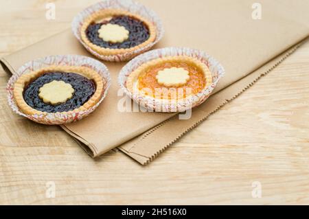 apricot and cherry jam short crust pastry in a paper backing cup on a ...