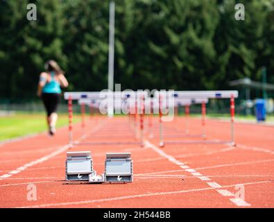 Obstacle course training. Athletics Starting Blocks and red running ...