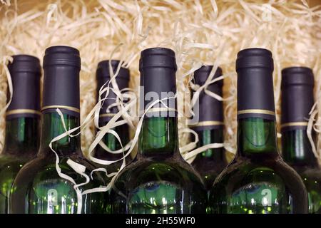 Green wine bottles in the box on the white table Stock Photo - Alamy