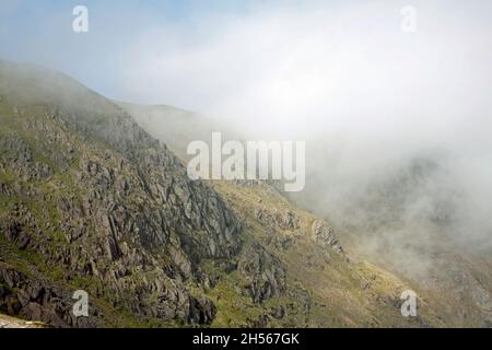 Mist swirling around the summit of Wetherlam viewed from the summit of ...
