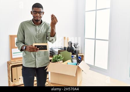 Young african american businessman unboxing box at the office smiling ...