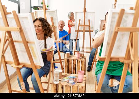 Group of middle age draw students sitting on the table drawing at art ...