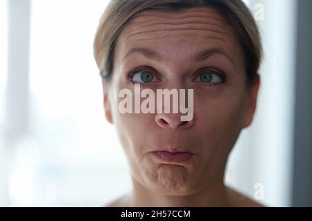 Silly mistake. Close up of cute asian girl saying sorry, shrugging ...