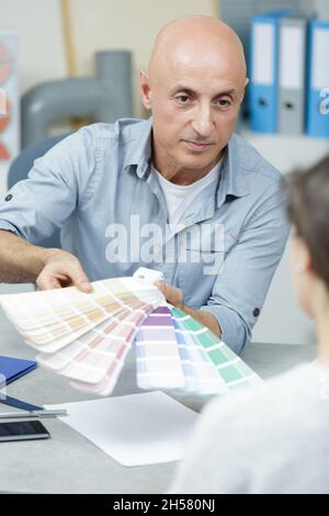 interior designer showing colour swatches to client Stock Photo - Alamy