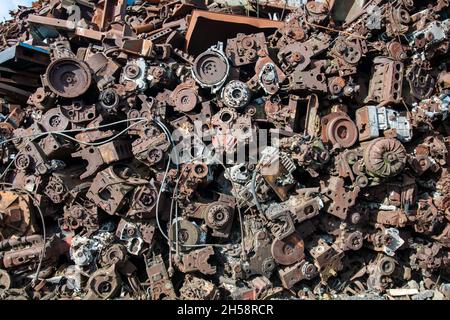 Piles of scrap internal combustion engines stacked in a scrap yard ...