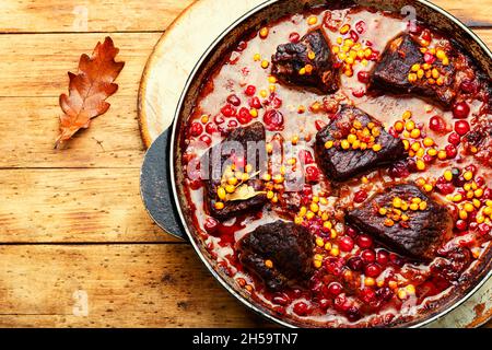 Beef roasted in autumn berries. Meat with cranberries and sea buckthorn ...