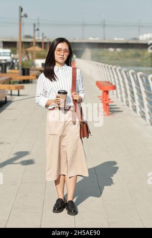 A chinese woman standing on large boulders within the desert ecosystem ...