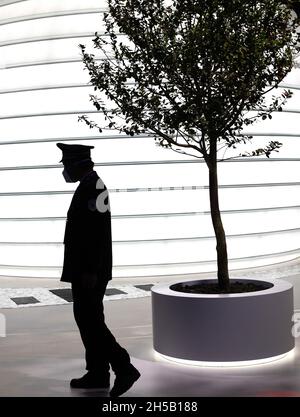 Expo staff member with face mask and traditional costume in The ...